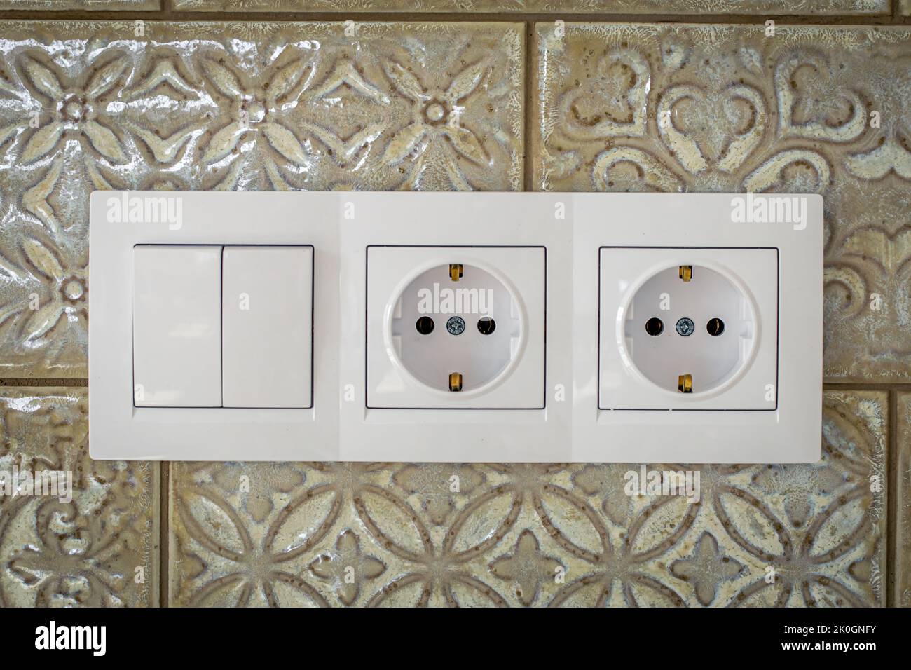 White plastic walk-through switches and sockets on a white wall Stock ...