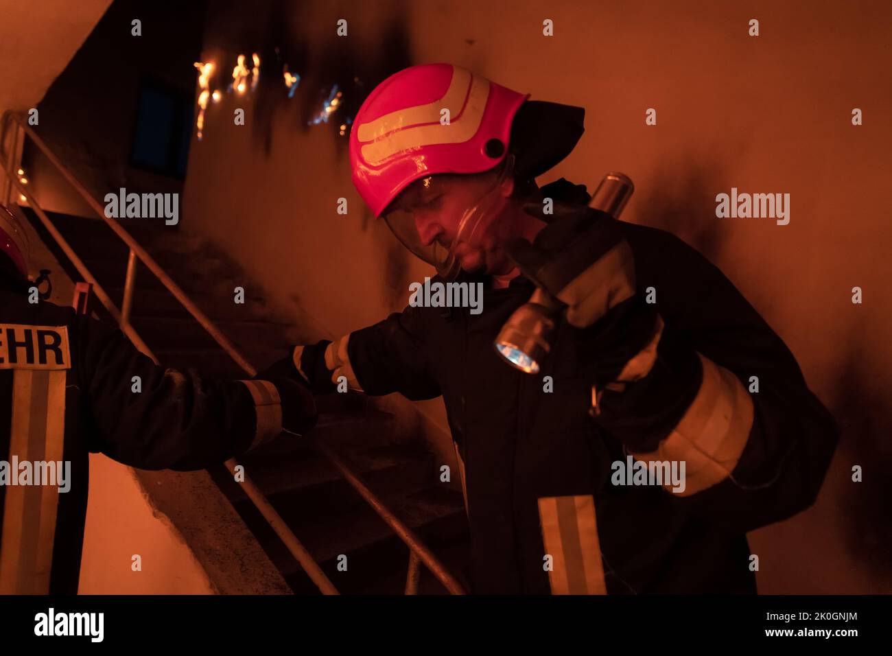 Brave Fireman Descends Stairs of a Burning Building and Holds Saved ...