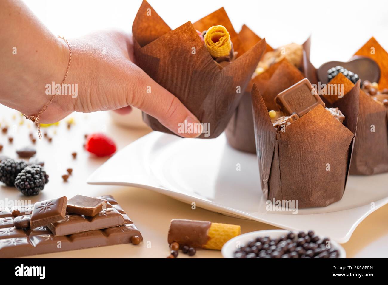 Chocolate cupcake.Appetizing cupcakes in hand on the table with sweets ...