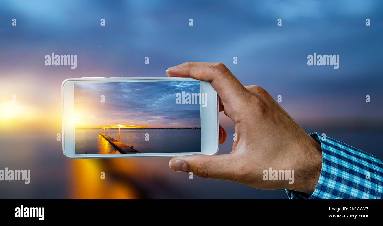 Hand holding smartphone mobile . Mixed media Stock Photo - Alamy