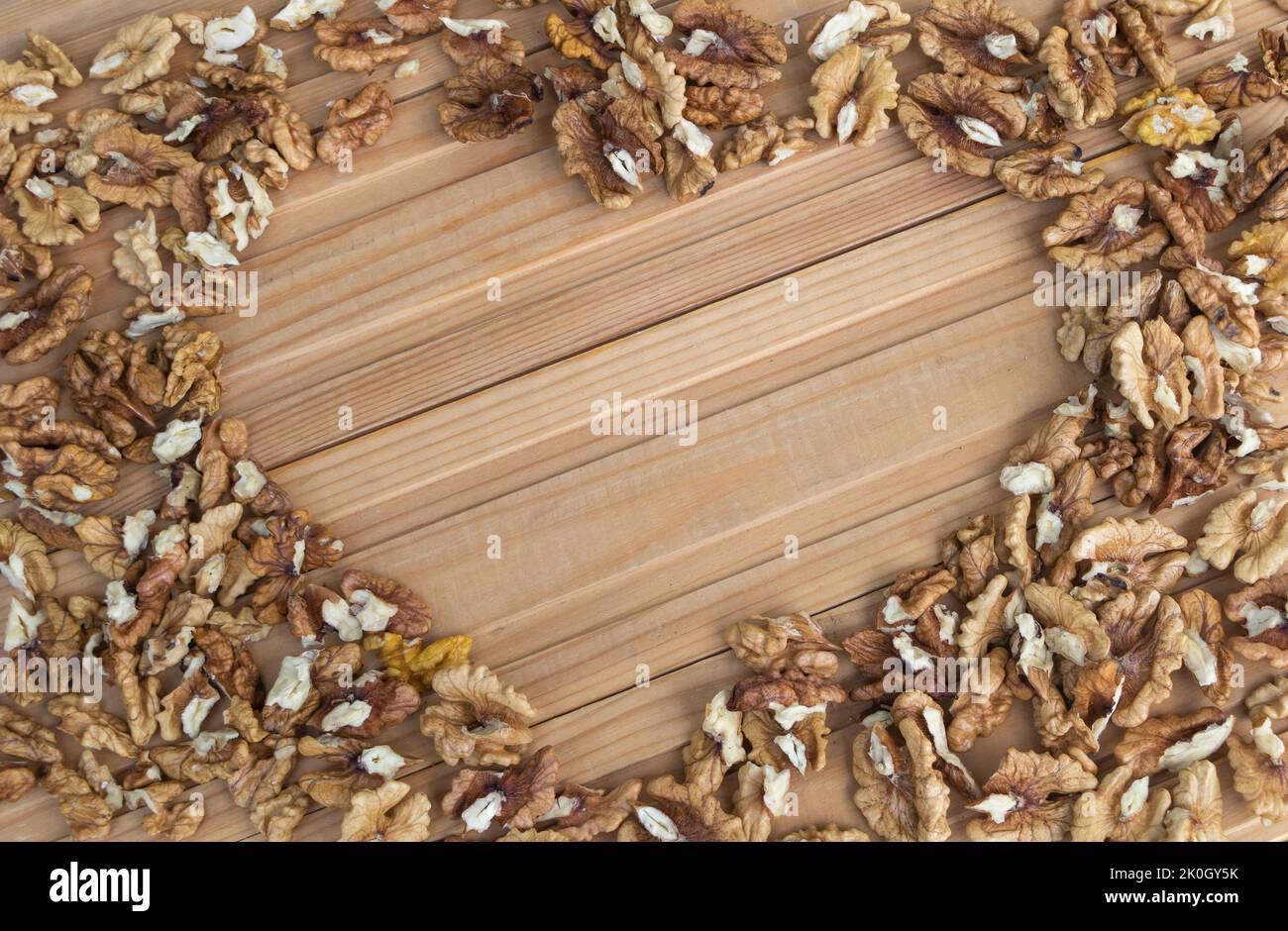 Fresh Walnut kernels on wooden background with copy space in a form of ...