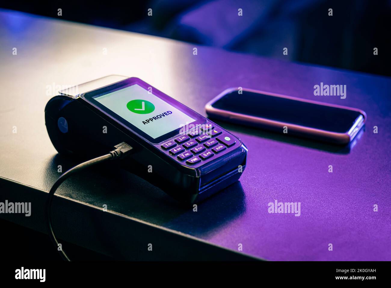 POS terminal, Payment Machine with mobile phone on dark background ...