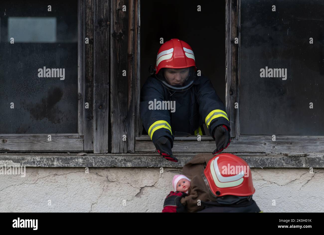 Firefighter hero carrying baby girl out from burning building area from ...