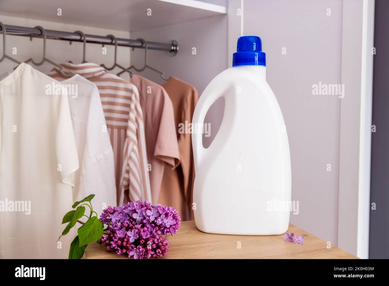 White detergent bottle mockup against the background of a wardrobe with ...