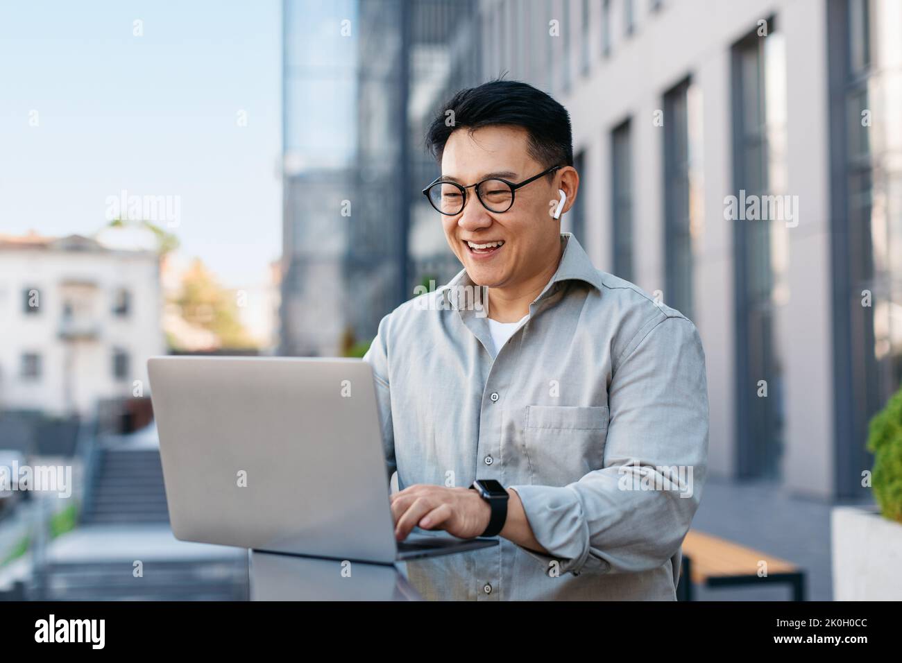 Confident korean middle aged businessman video calling on laptop ...