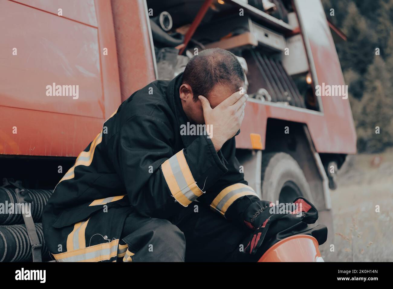 depressed and tired firefighter near fire truck Stock Photo - Alamy