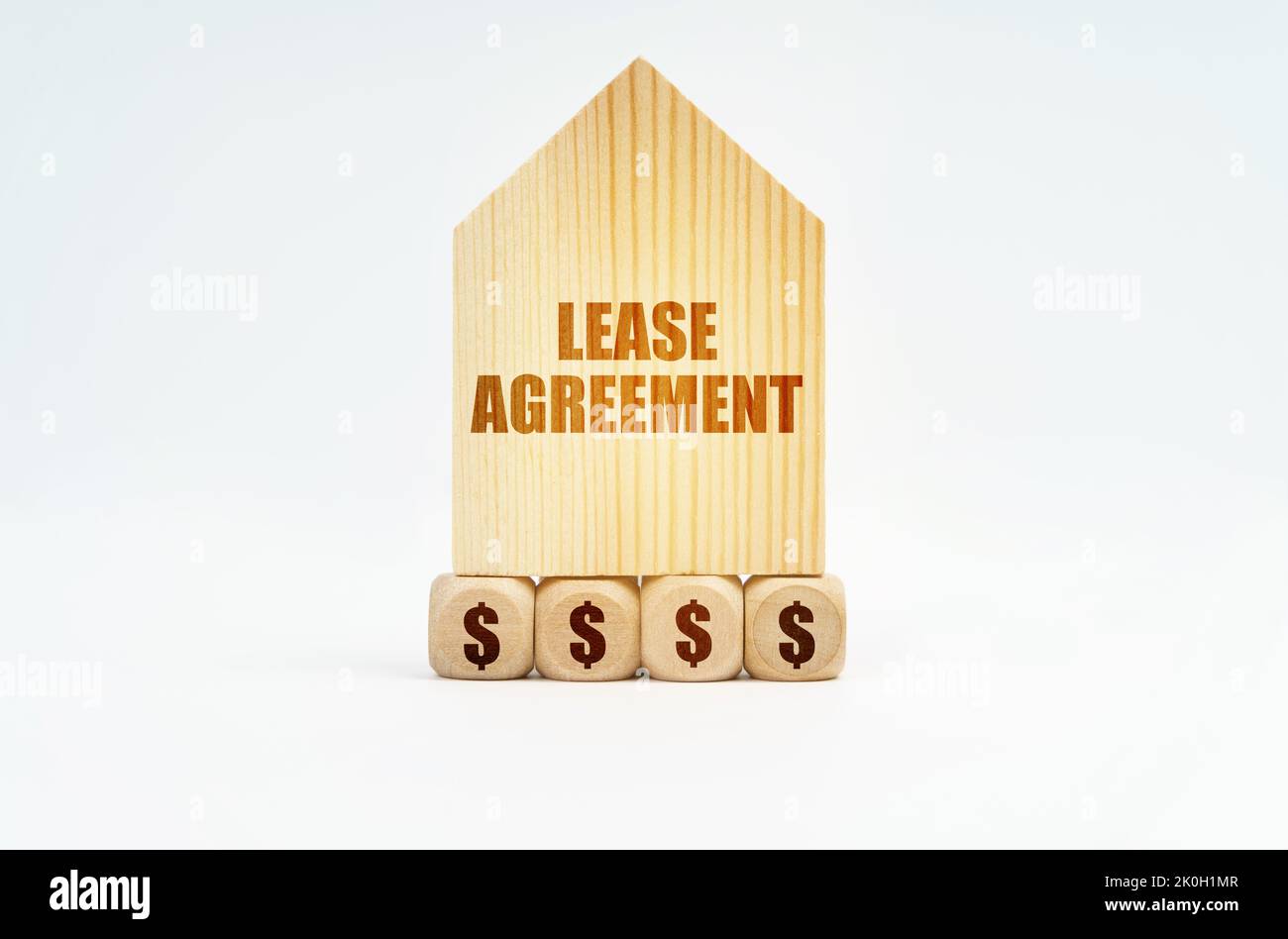 Real estate and business. On a white surface stands a wooden model of a ...