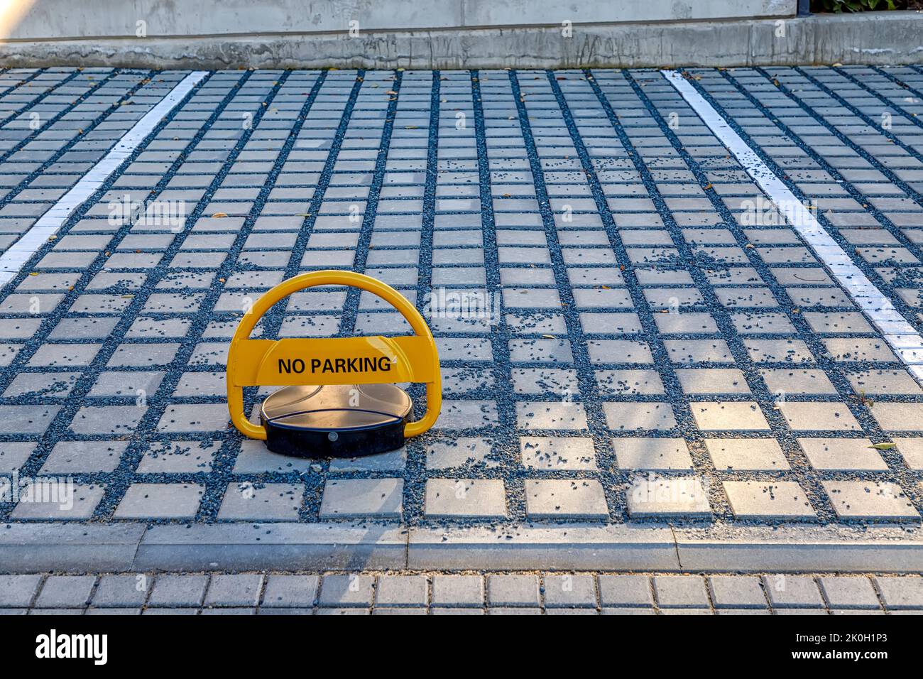 Parking lot barrier locked with padlock protecting from improperly ...