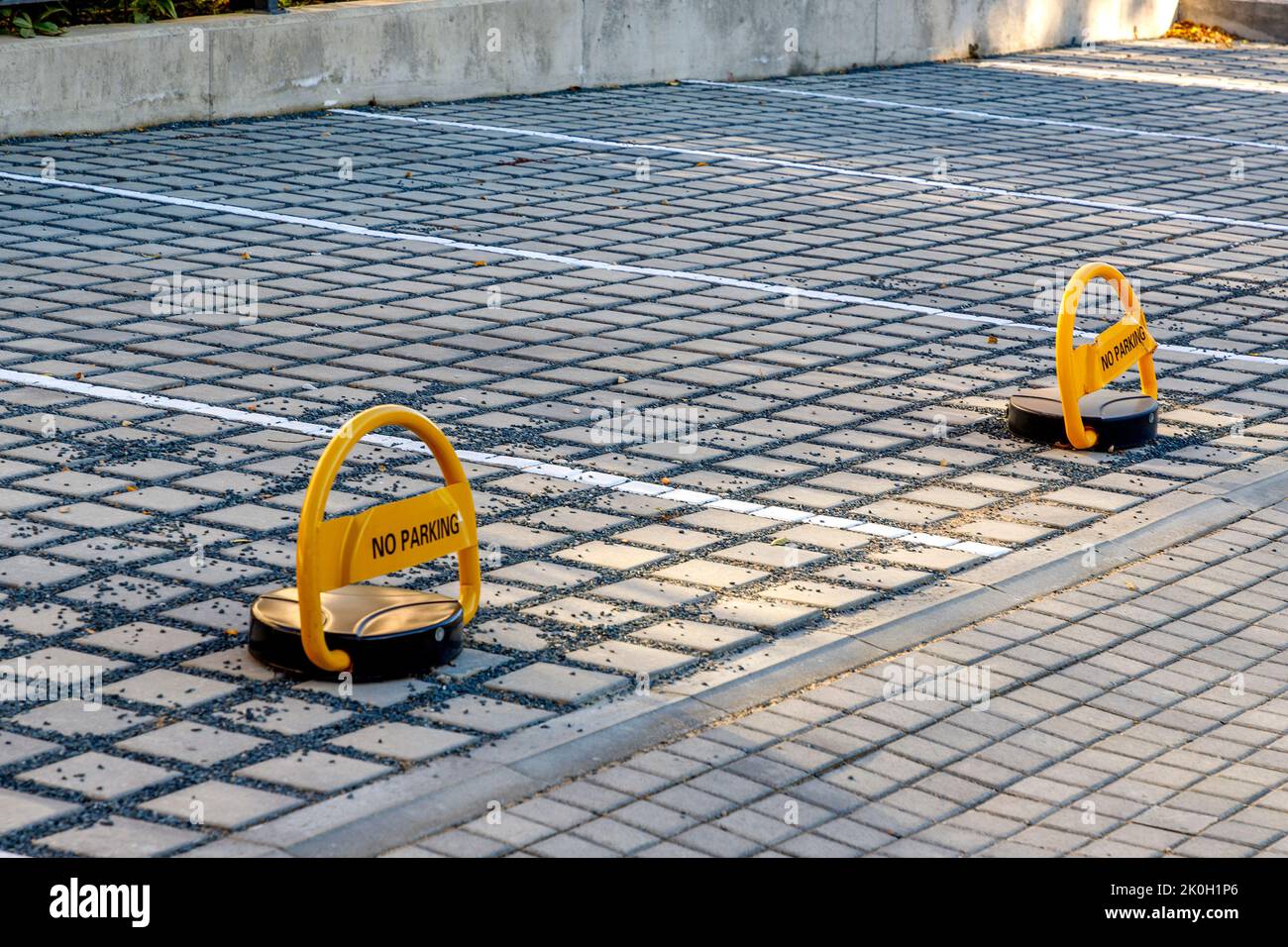 Metal barriers for private outdoor parking lot Stock Photo - Alamy