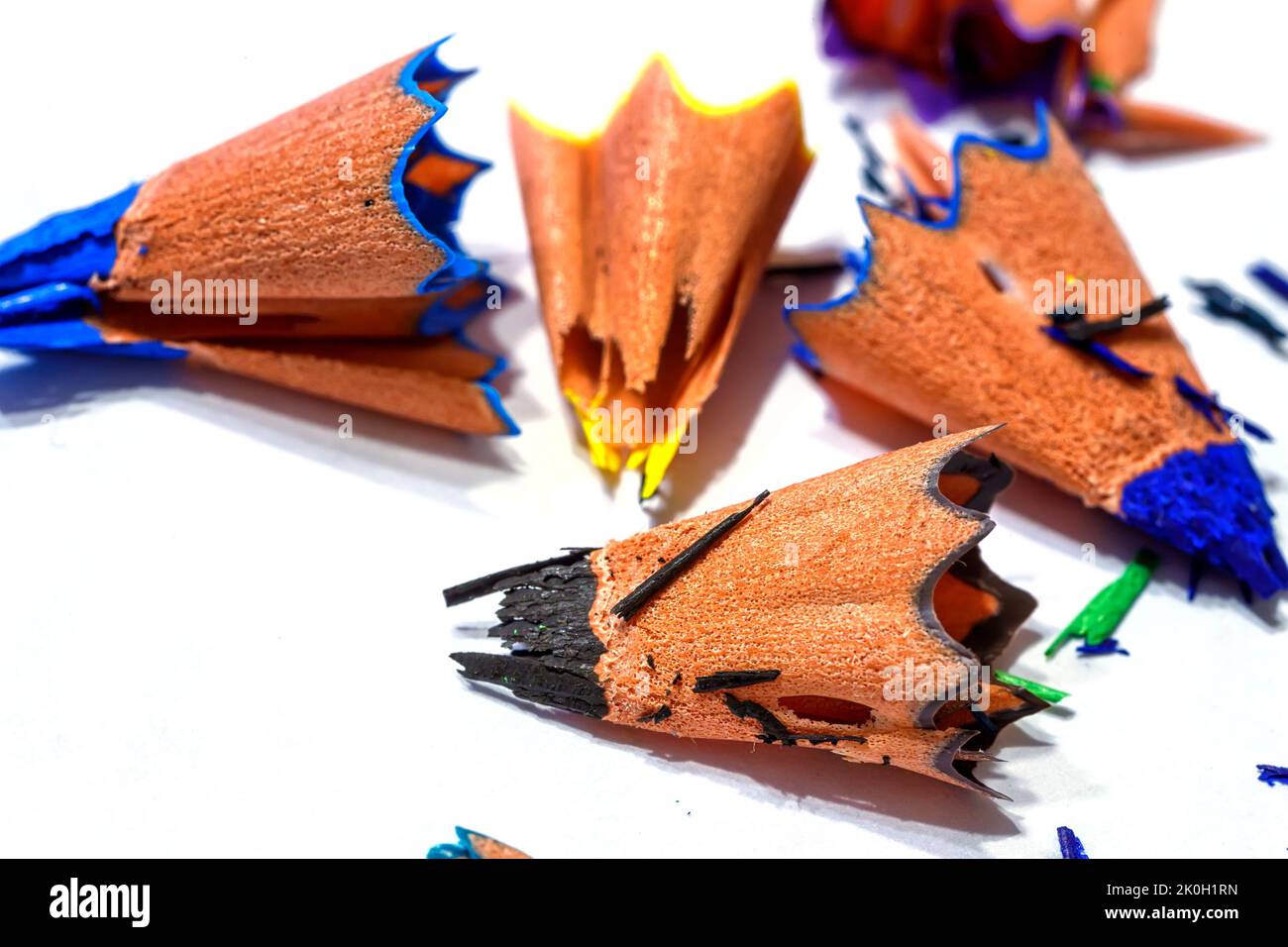 Wooden shavings of colored pencils on a white background. Fine shavings ...