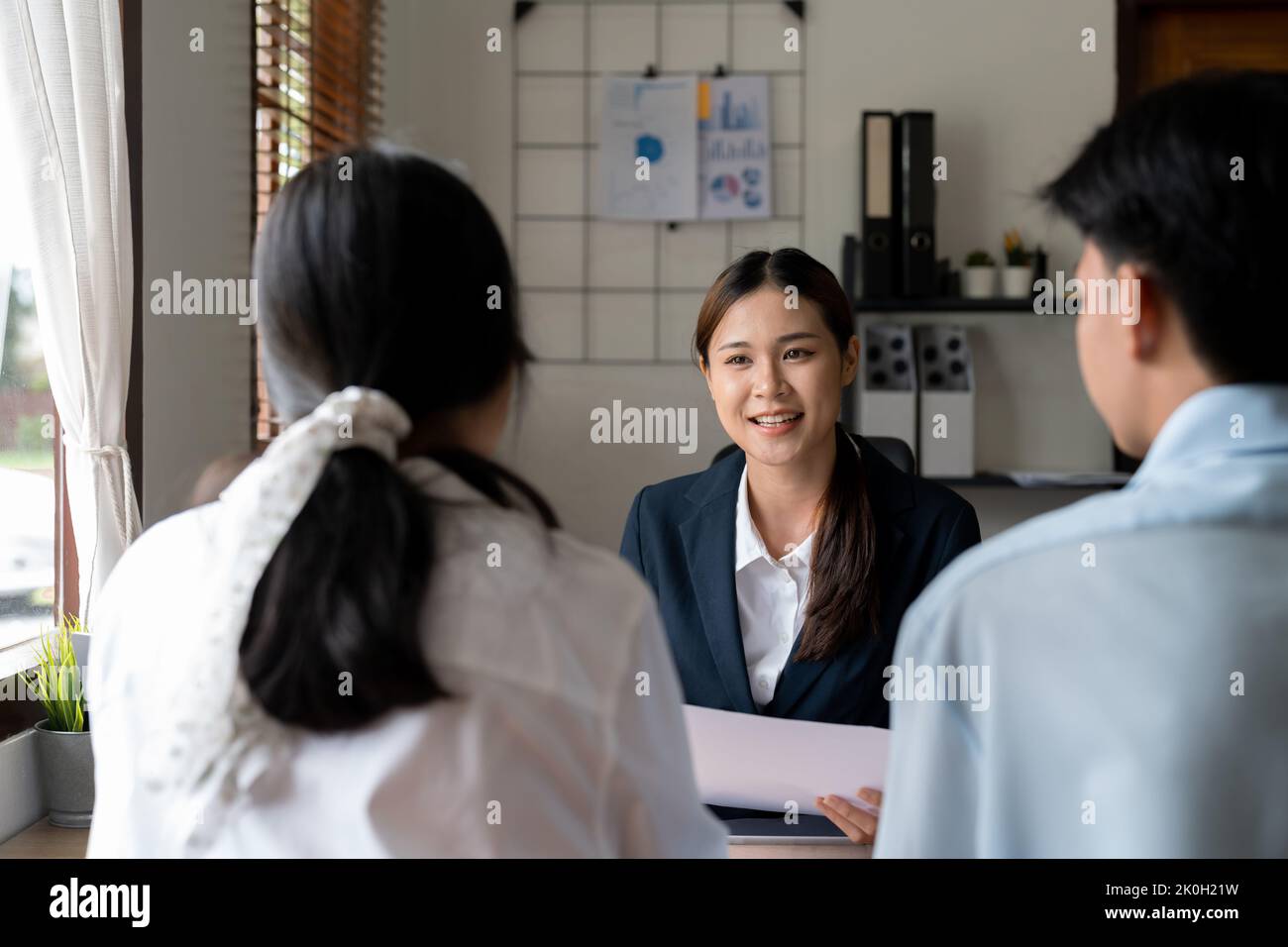 Asian female Real Estate agent offer home ownership and life insurance ...