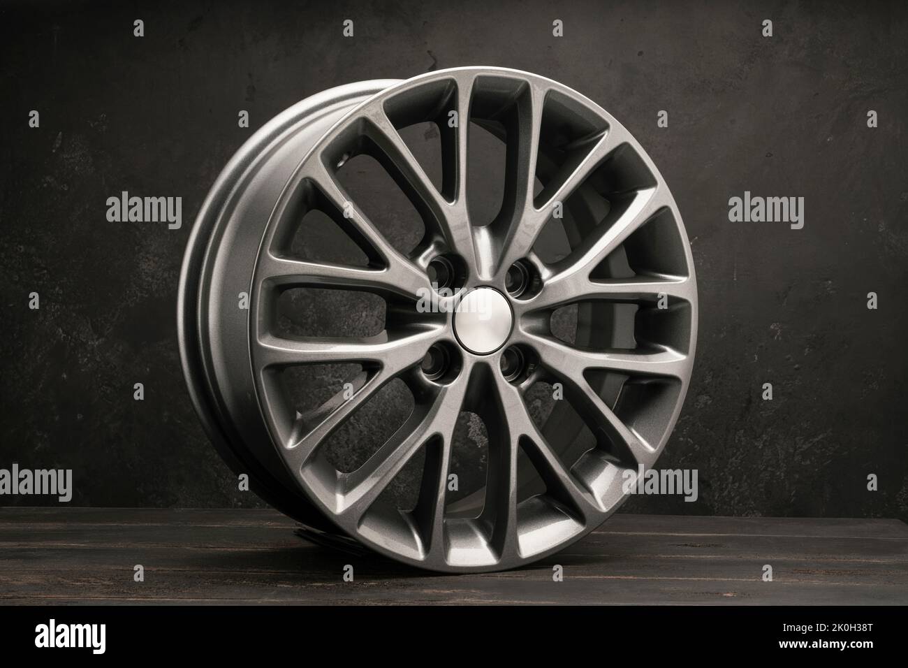 new grey allonew grey alloy wheels on a dark textured black background ...