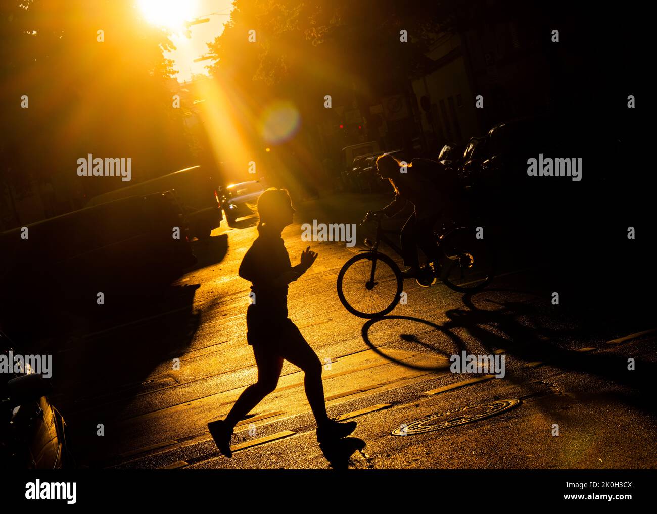 Munich, Germany. 12th Sep, 2022. A woman jogs across the shimmering ...