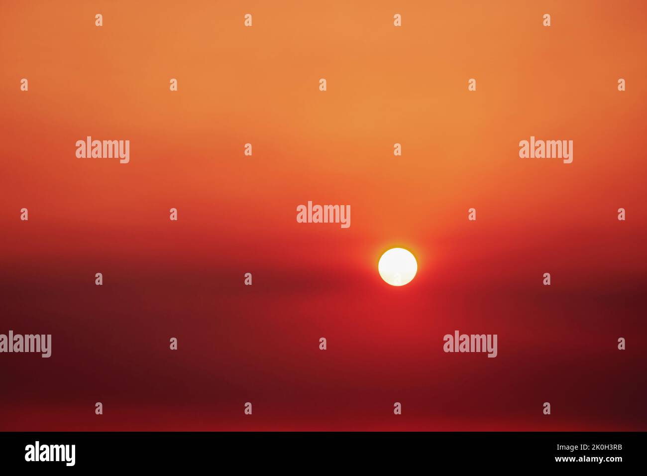 A big red sun in the sunset sky, a summer landscape. Evening sky in hot ...