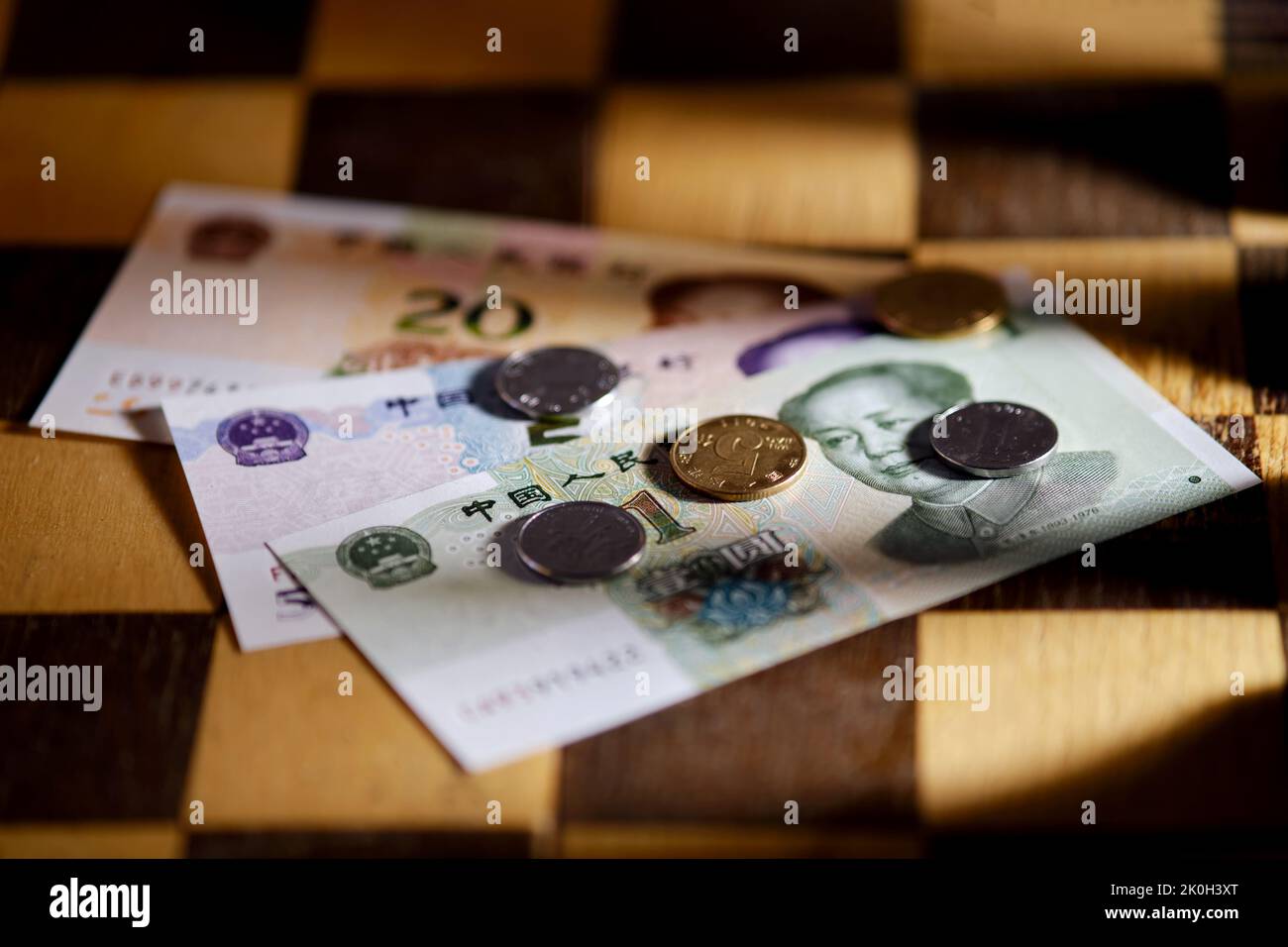 Chinese yuan money on the background of a chess board. Banknotes and ...