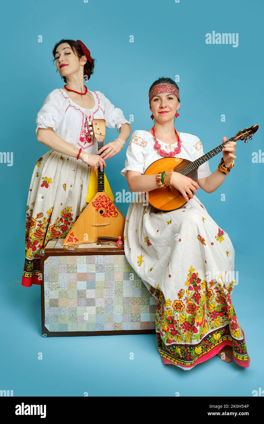 Women musicians in Russian folk dresses with musical instruments on a ...
