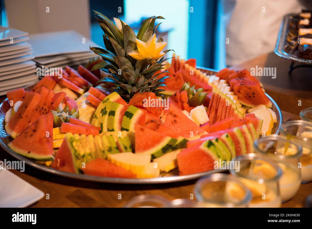 A closeup of a buffet table with fresh watermelon. melon. and pineapple ...