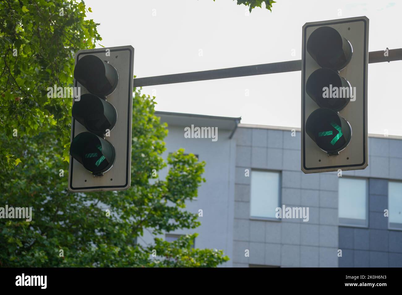 Two traffic lights showing a green light for cars turning right the ...