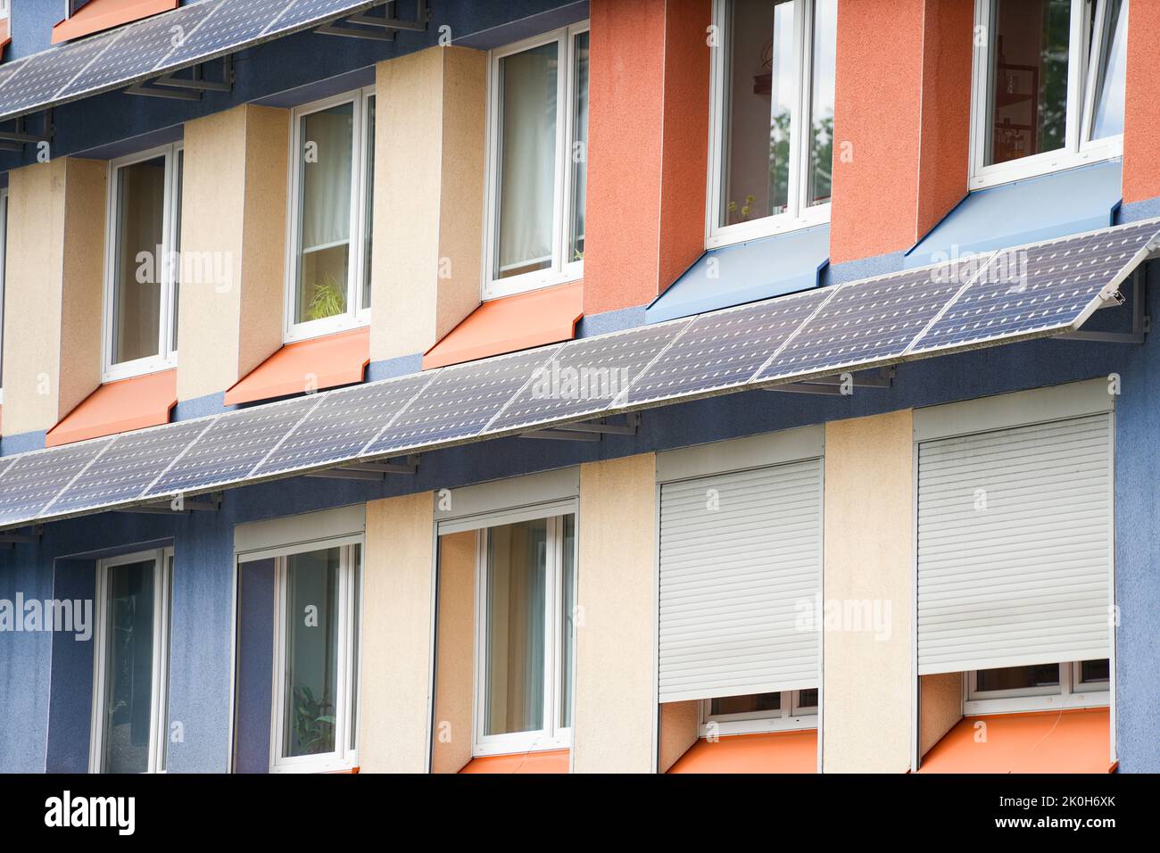 A facade of a colorful residential building with solar batteries Stock ...