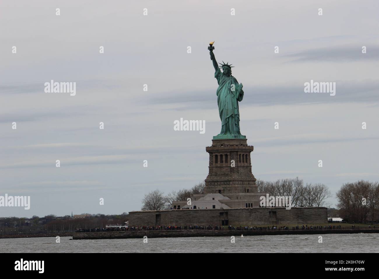 The Statue of Liberty on blue cloudy sky background from Upper New York Bay Stock Photo - Alamy