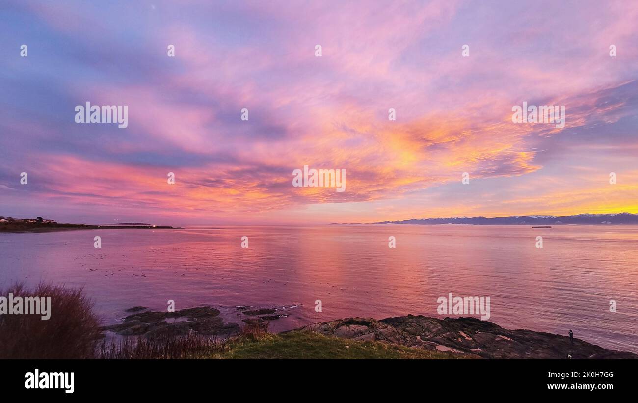 A beautiful view of a lake with a cloudy sky during orange sunset Stock ...