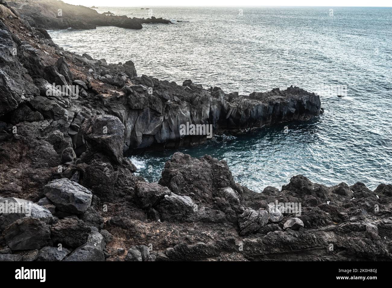 Basalt rocks in the ocean. Volcanic texture of vertical columns at the ...