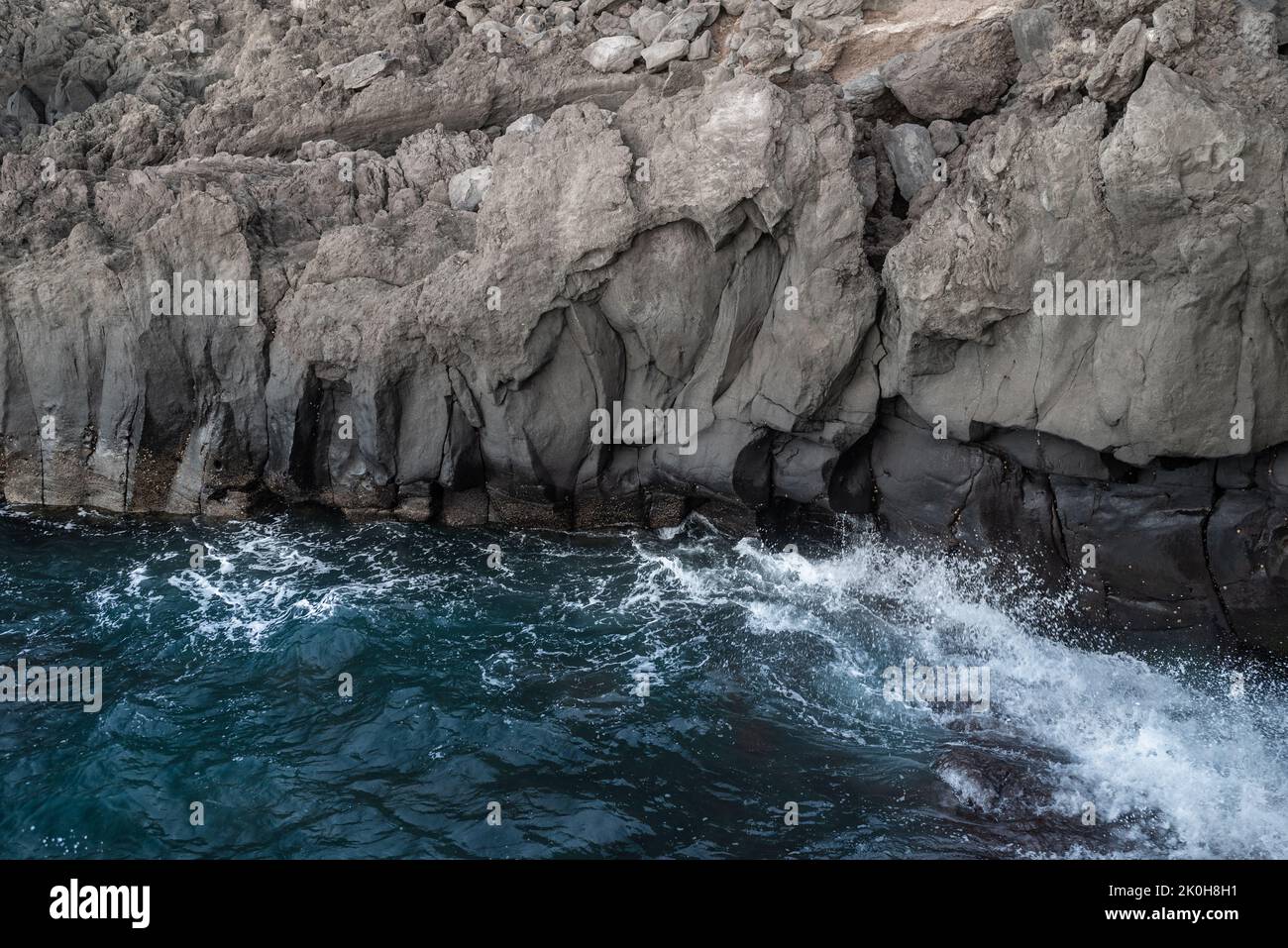 Basalt rocks in the ocean. Volcanic texture of vertical columns at the ...