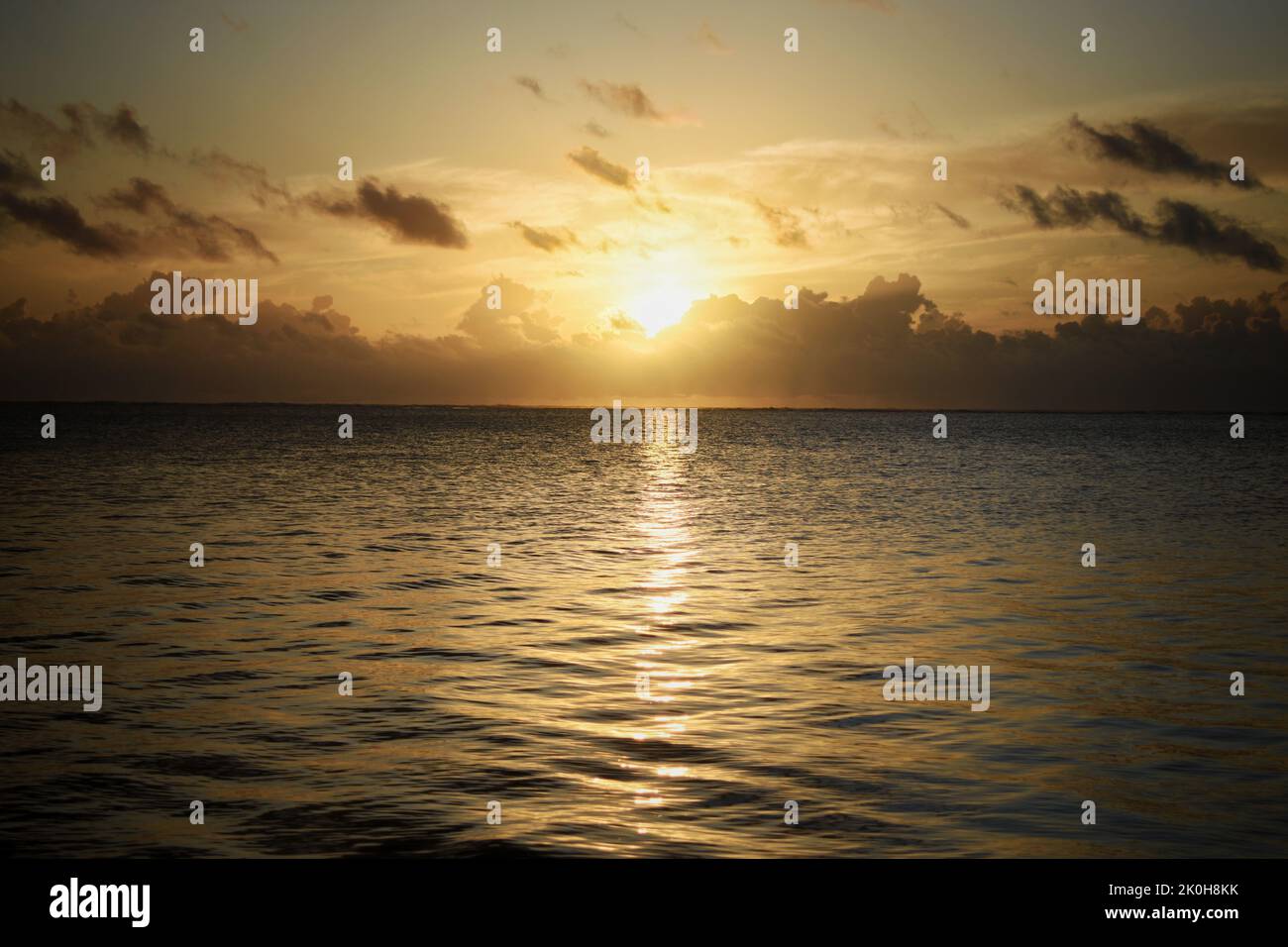 A beautiful scenery of calm ocean at sunrise Stock Photo - Alamy