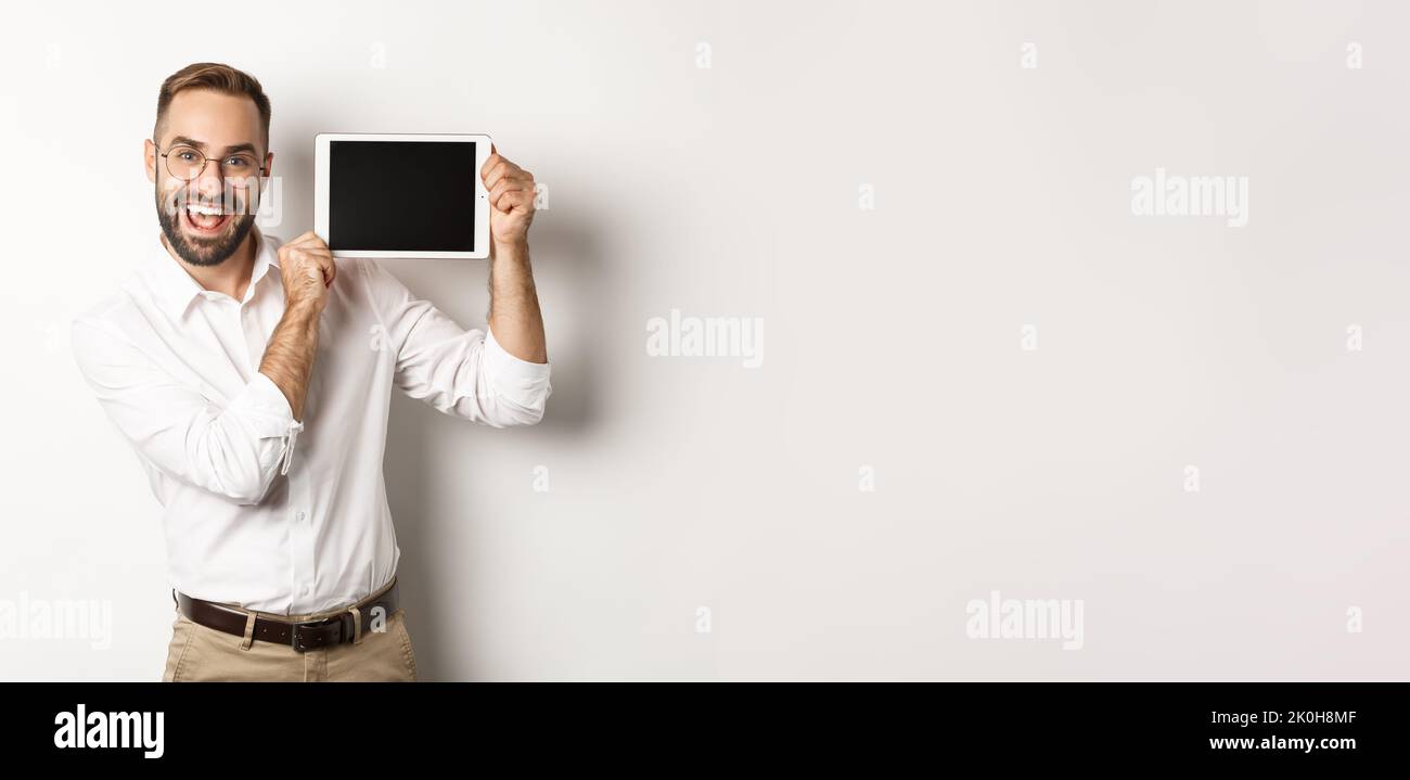 Shopping and technology. Handsome man showing digital tablet screen ...