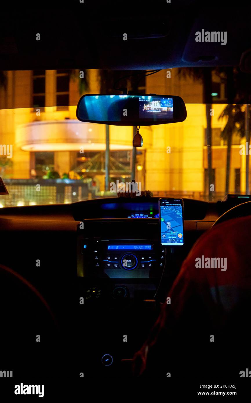interior of a car driving night rainy city. blurred city lights. Kuala ...