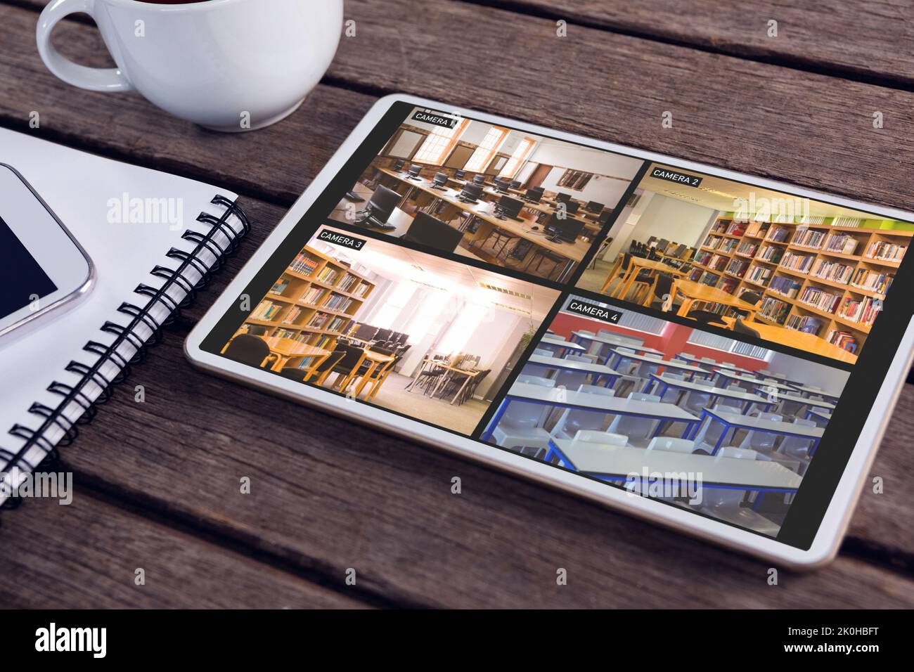 Tablet with view from security cameras at library on screen, lying on ...