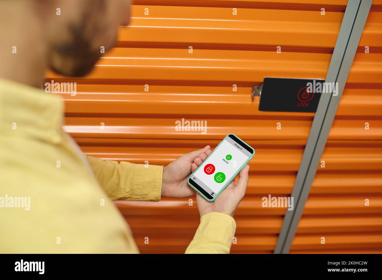 Warehouse employee opening the smart lock using the smartphone app ...