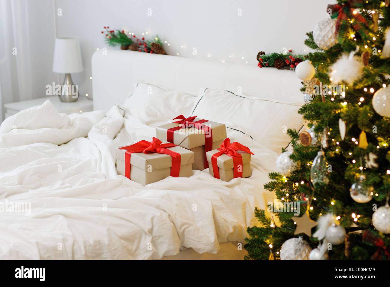 gify boxes on the bed in decorated bedroom with beautiful christmas ...