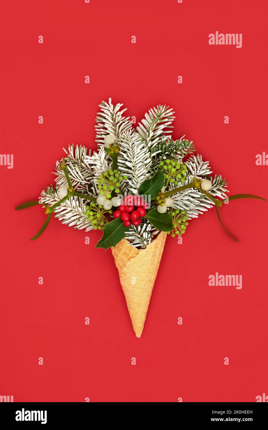Christmas surreal ice cream cone concept with snow covered fir and ...