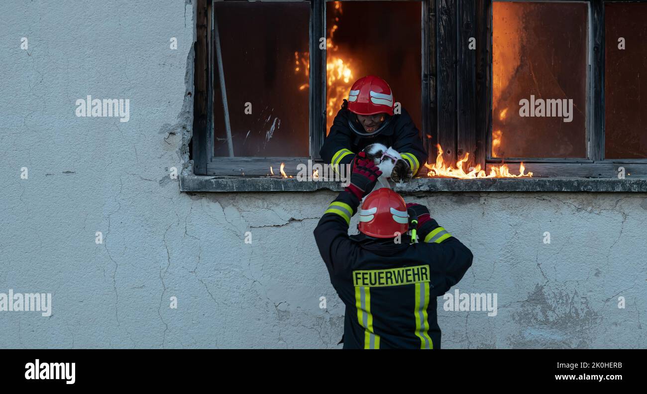 Firefighter hero carrying baby girl out from burning building area from ...