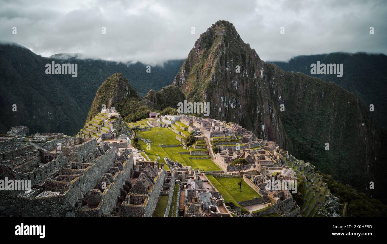A closeup of a Machu Picchu landscape at sunset with a cloudy sky ...
