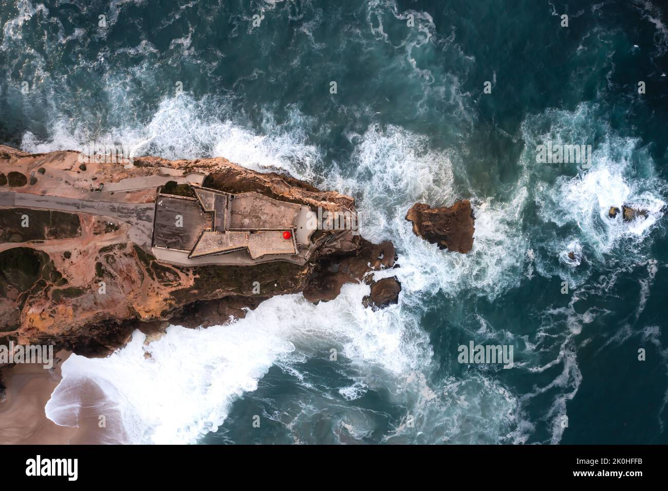 An aerial view of a rocky coast along a blue ocean in daylight Stock ...