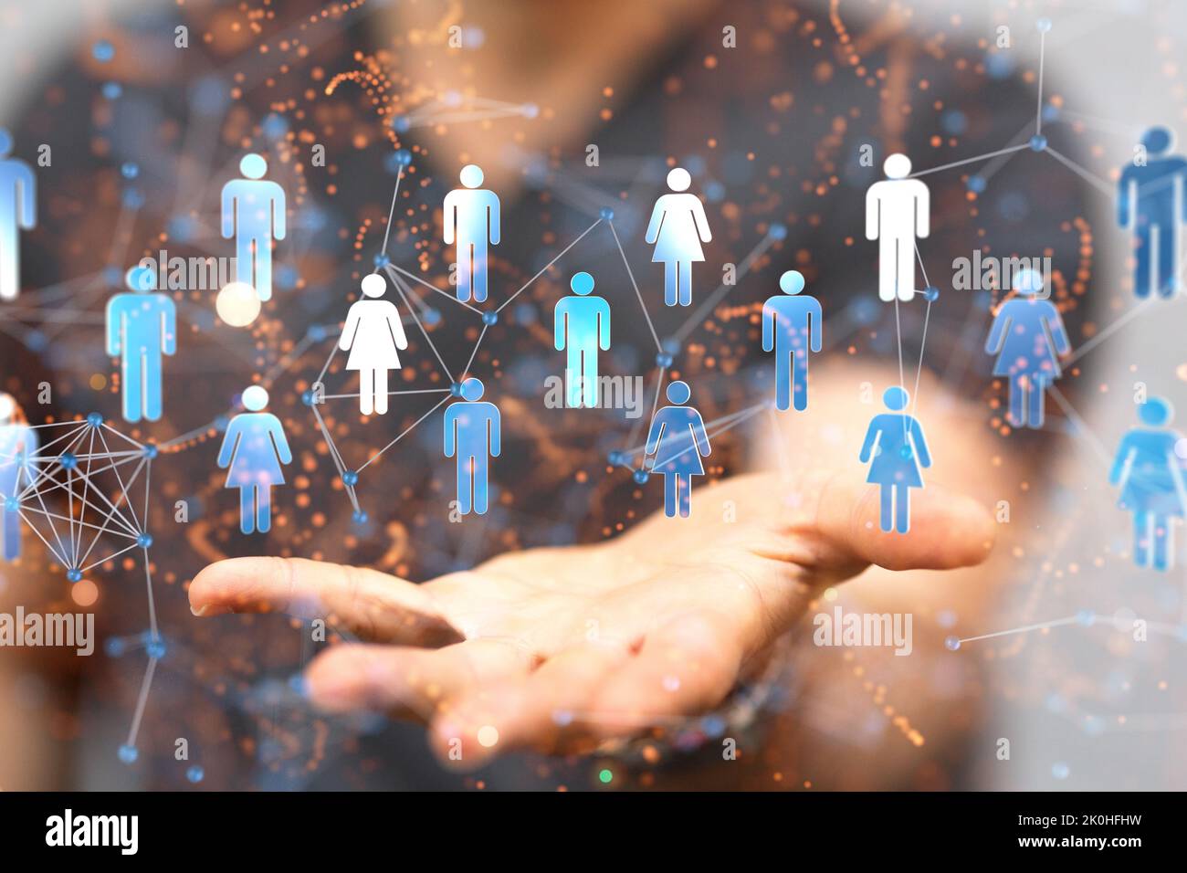 A group of 3D rendered people icons hovering over a man's hand Stock Photo - Alamy