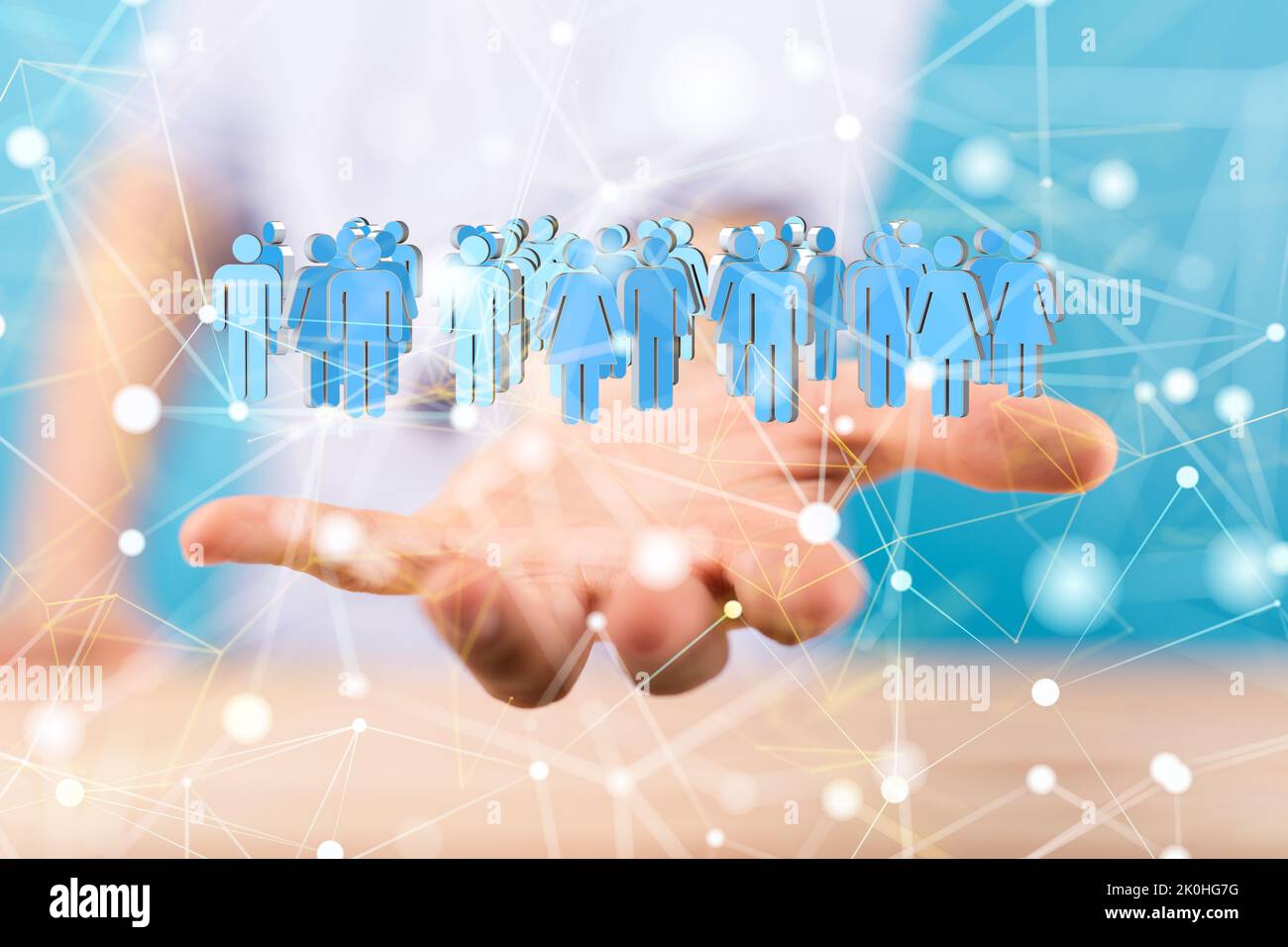 A group of illustrated people icons floating above a hand Stock Photo ...