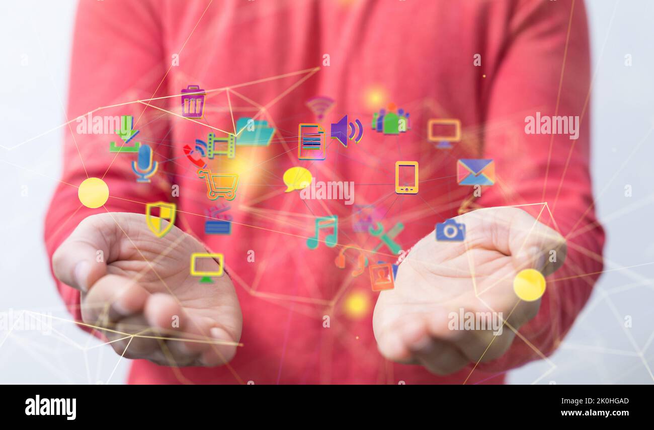 The illustrated application icons floating above hands Stock Photo - Alamy