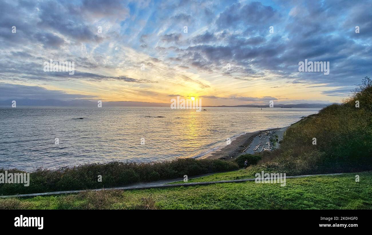 The beautiful view of the lakeshore with a cloudy sky during the sunset ...