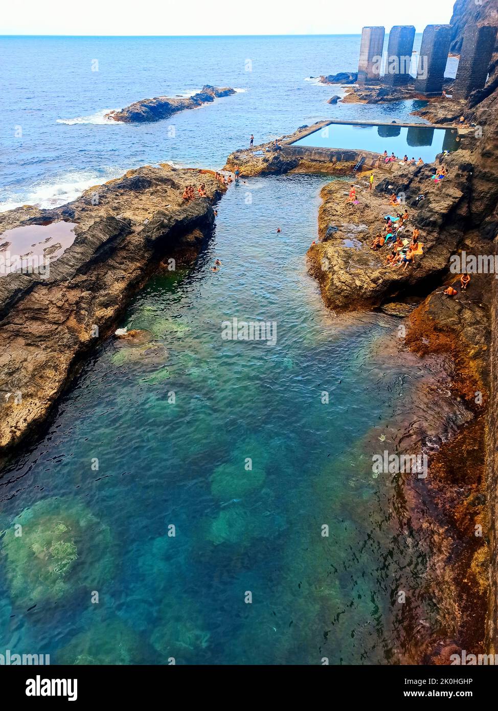 Magical seascape view with volcanic walls of natural pool in town of ...