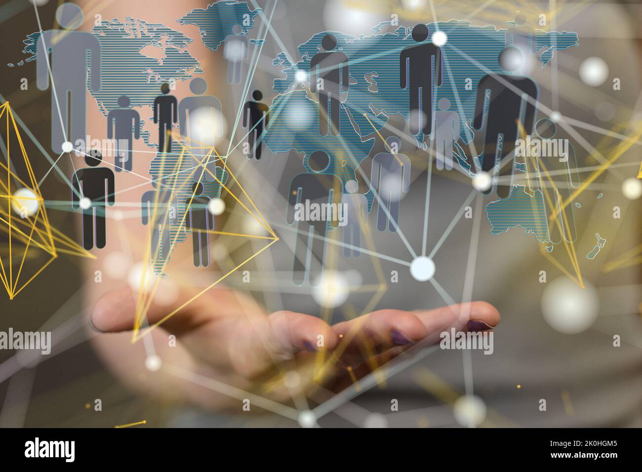 A group of illustrated people icons floating above a hand Stock Photo ...