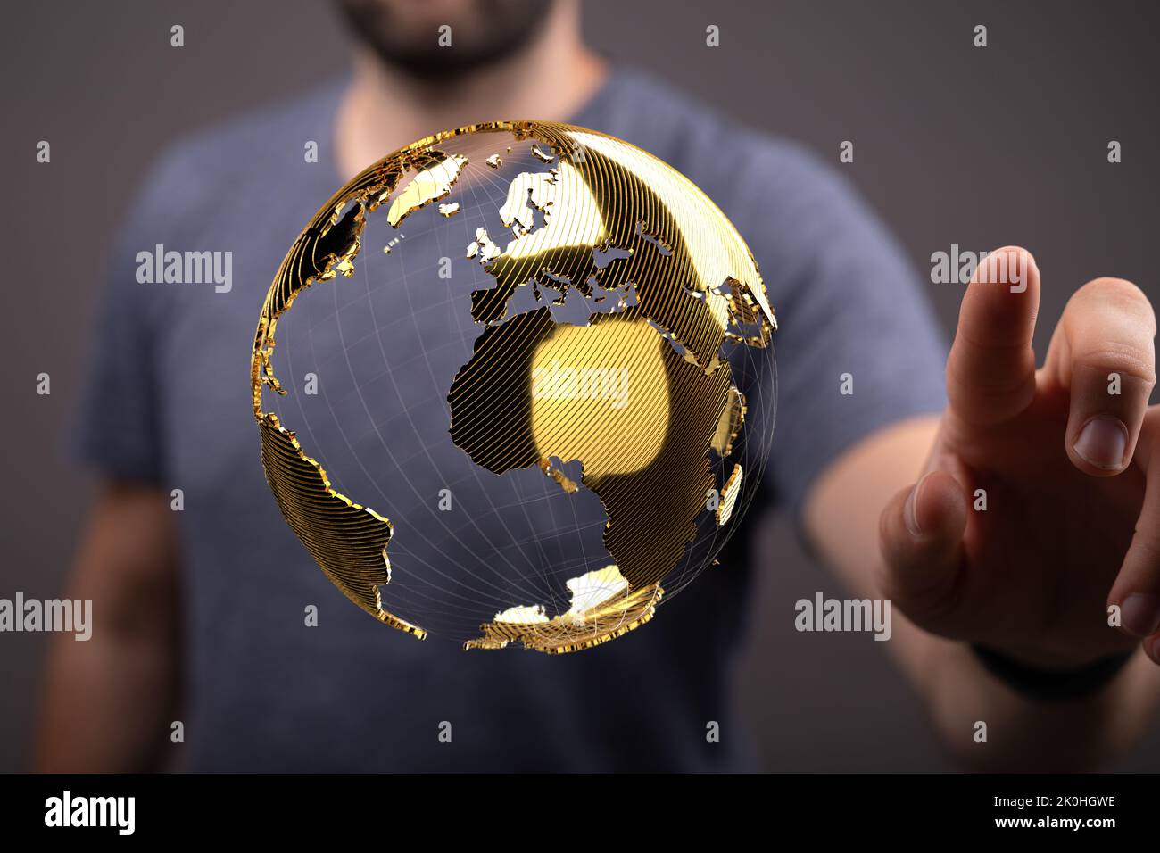 a golden hologram of the globe with a man pointing his finger Stock ...