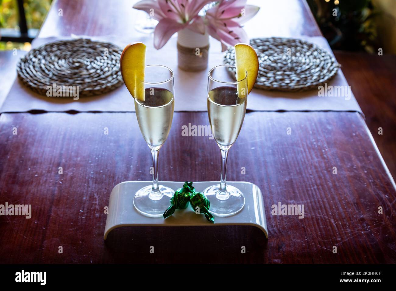 set of two champagne cocktails on dining table Stock Photo - Alamy
