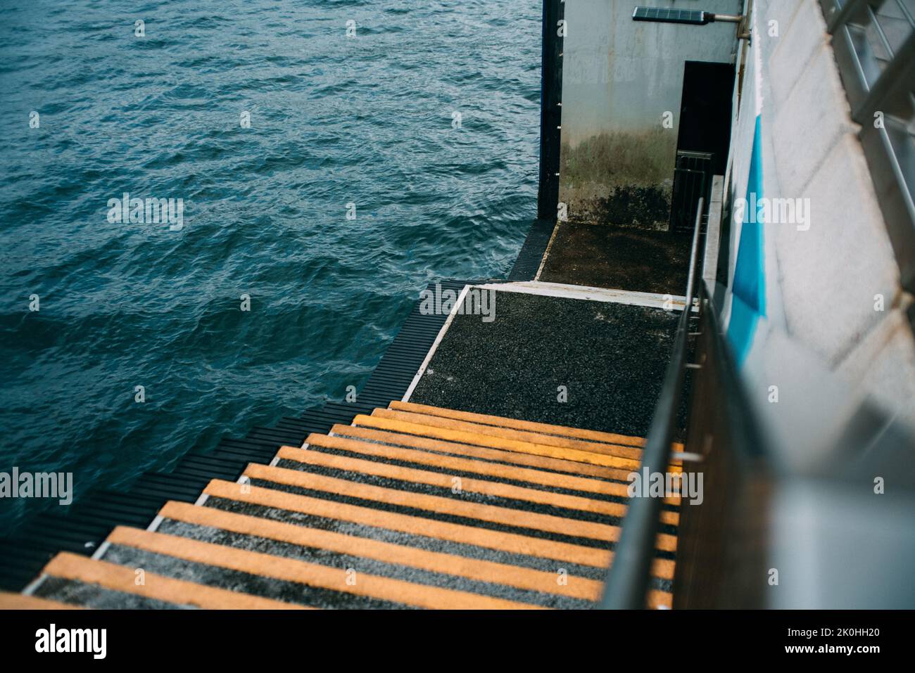 A high-angle shot of stairs to the water with sea waves on the floor ...