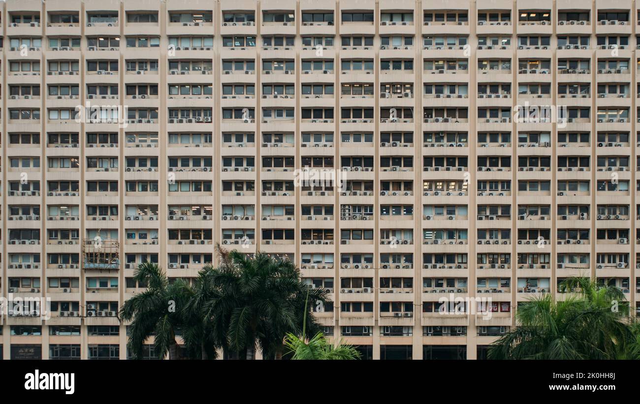 A building facade with windows and trees around Stock Photo - Alamy