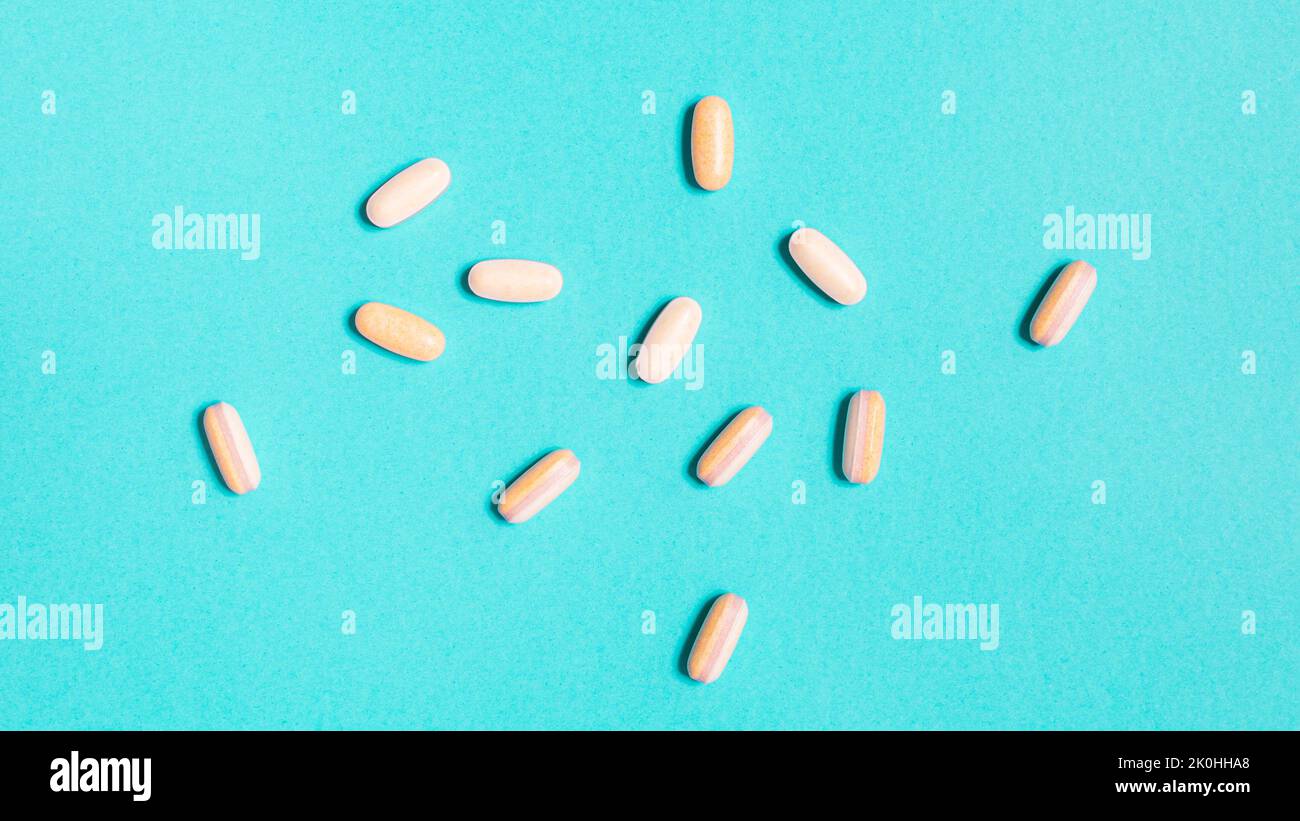 Tablets drugs therapy antibiotic on pastel blue background from above ...