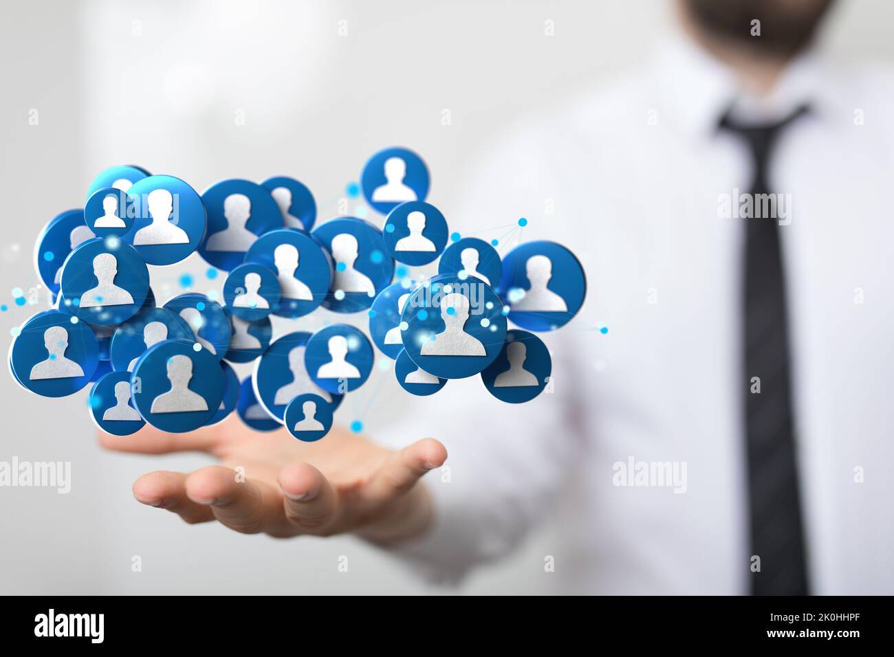 A businessman presenting 3D rendered user icons hologram on the palm of ...