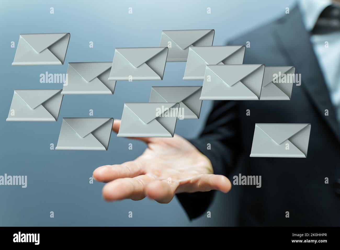 A person showing 3d mail icons on a blurred background Stock Photo - Alamy